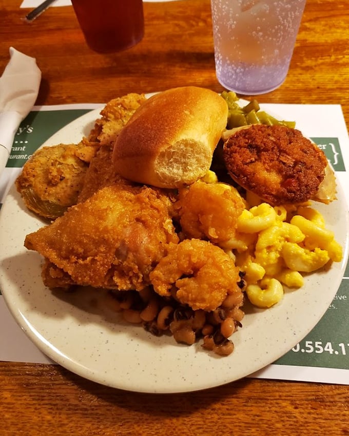A plate that sings the greatest hits of Southern comfort—fried chicken with that perfect crunch, mac and cheese, and a roll that's begging for butter.