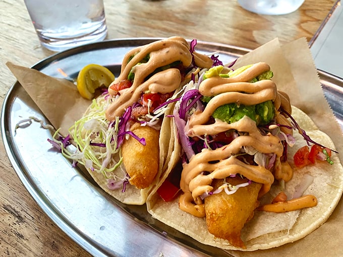Fish tacos that deserve their own Instagram account – crispy fish, vibrant slaw, and that sauce drizzled with the confidence of a chef who knows they've nailed it.
