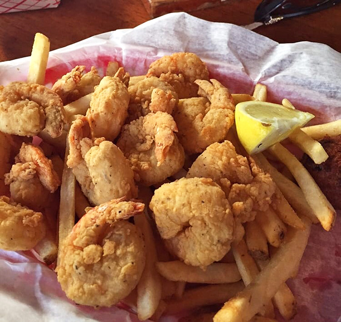 Golden-fried shrimp nestled among crispy fries – the kind of basket that makes you forget you ever knew the word "cholesterol."