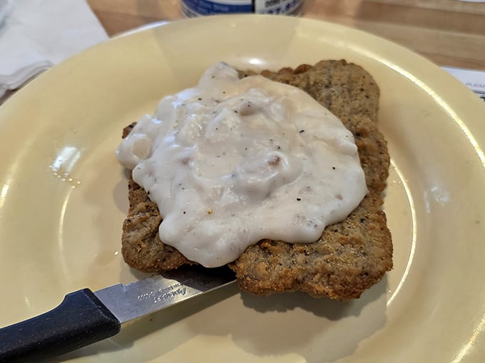 Country fried steak smothered in gravy – where comfort food meets cardiac concern, and nobody's complaining about either.