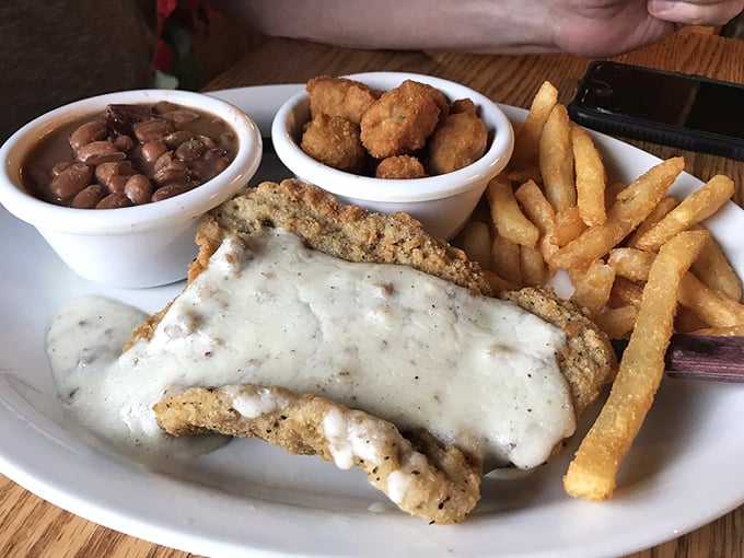 Country fried steak smothered in gravy with a side of pintos—a plate that whispers "welcome home" even if you're just passing through.