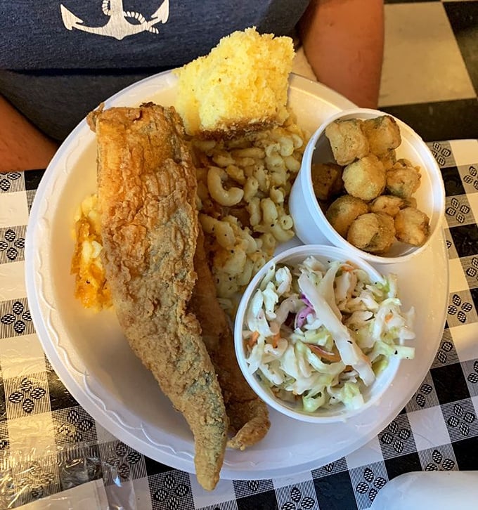 Perfectly fried fish with mac and cheese, hushpuppies, and coleslaw – a plate that makes you want to send a thank-you note to whoever invented breading.