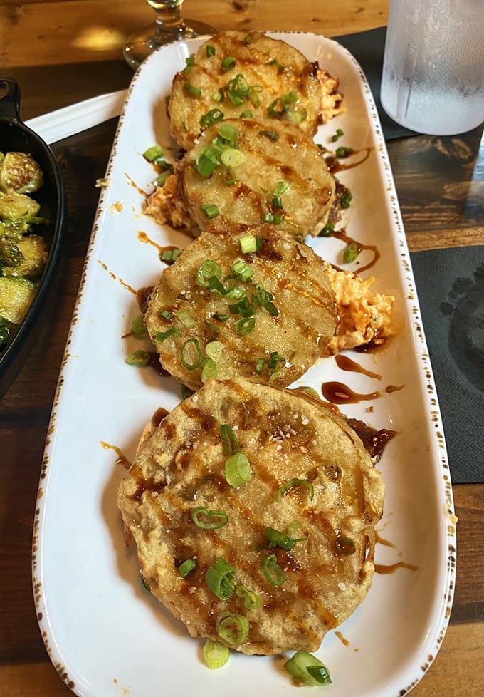 The fried green tomatoes—our article's stars—arrive golden and crispy, topped with green onions and a drizzle that makes them irresistible.