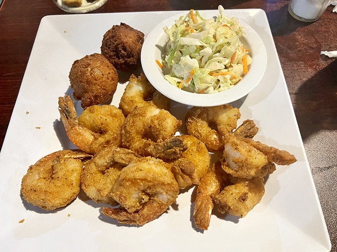 Golden-fried shrimp that crunch like autumn leaves, paired with hush puppies that could make even the chattiest dinner companion fall silent.