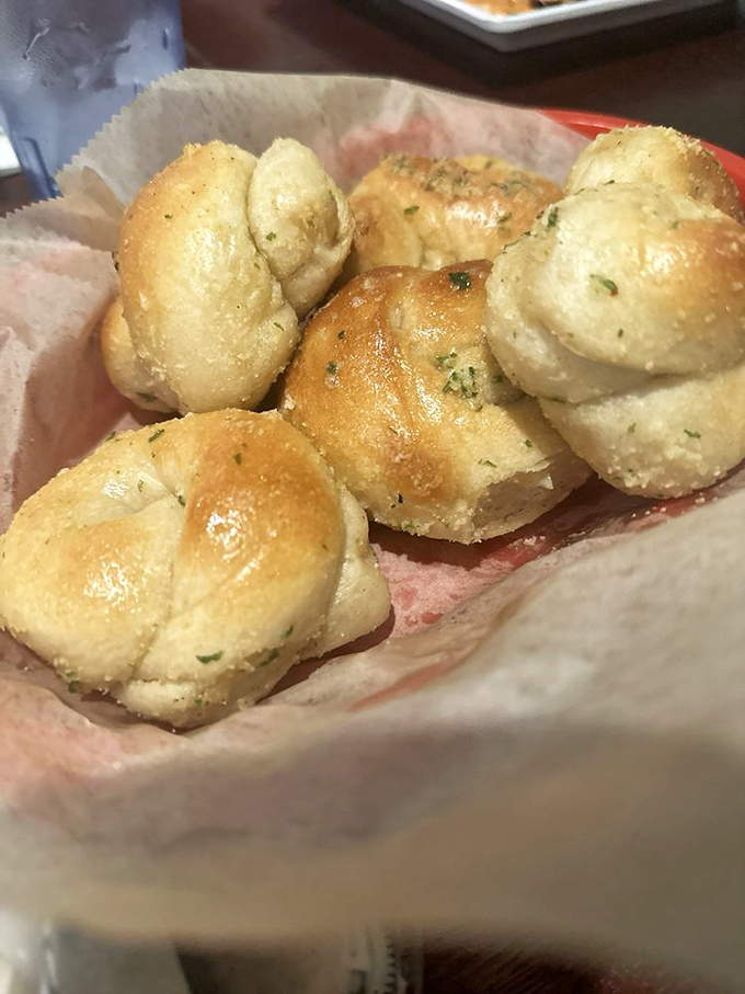 These garlic knots aren't just bread starters – they're buttery, herb-flecked pillows of joy that threaten to steal the spotlight from the main event.