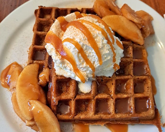 This vanilla bean waffle topped with caramel sauce and seasonal fruit isn't just breakfast—it's what angels eat when no one's looking. 