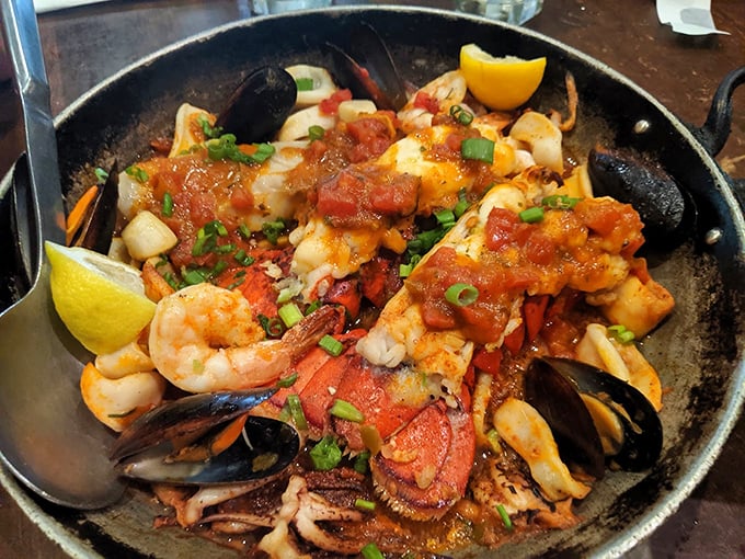 A seafood symphony in a cast iron skillet—this Greek-style paella brings together shrimp, mussels, and fish in a tomato bath that would make Poseidon himself request seconds.