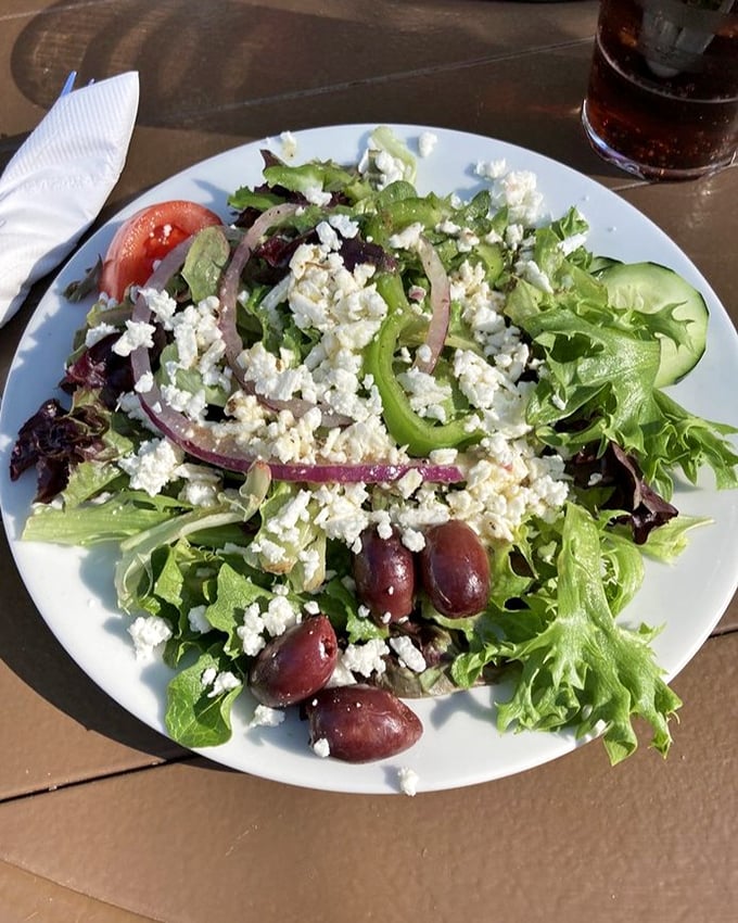 A proper Greek salad that respects the classics—crisp greens, briny olives, and generous feta chunks that haven't been hiding in the refrigerator for weeks.