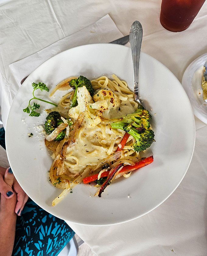 Pasta perfection that would make an Italian grandmother nod in approval – creamy fettuccine Alfredo with fresh vegetables that's worth every carb.