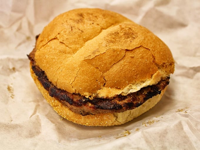 This isn't just a burger—it's a charcoal-kissed masterpiece on a Manderfield's hard roll that makes fast food chains weep with inadequacy.