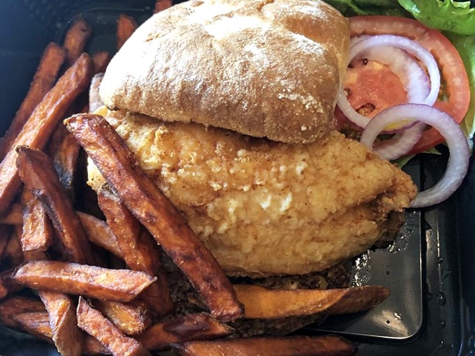 This golden-fried grouper sandwich isn't just lunch—it's Florida on a bun. Those sweet potato fries deserve their own fan club.