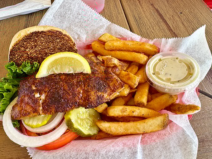 This blackened grouper sandwich isn't just lunch—it's a Florida ritual, complete with the mandatory pickle spear standing guard.