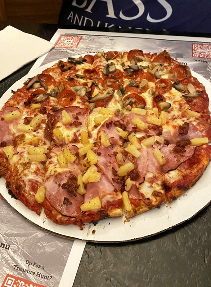 Hawaiian pizza skeptics, prepare for conversion. This ham and pineapple masterpiece makes a compelling case for tropical toppings that even Italians might forgive.