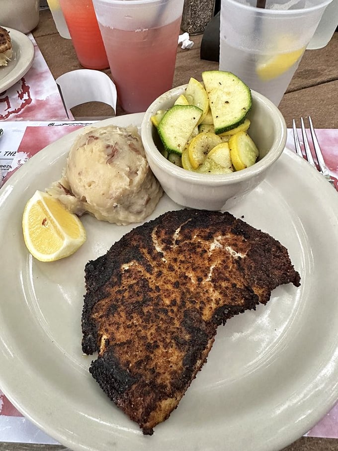 Blackened fish with a golden crust that crackles like autumn leaves, sided by vegetables that actually taste alive.