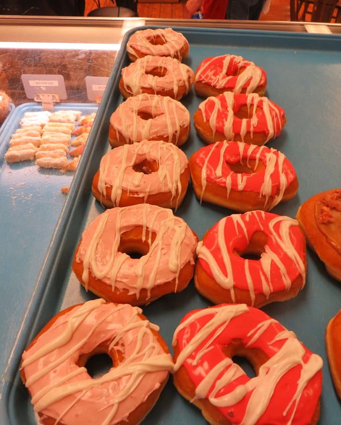 These aren't just donuts—they're works of art with holes in the middle. The pink-frosted beauties drizzled with white icing would make Homer Simpson weep with joy.