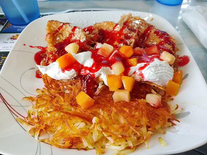 French toast crowned with fresh fruit and whipped cream. The crispy hash browns aren't playing a supporting role—they're co-starring in this breakfast blockbuster.