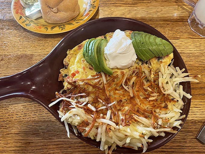 This skillet masterpiece isn't just breakfast—it's edible architecture. Crispy hash browns form the foundation for a morning masterpiece topped with fresh avocado.