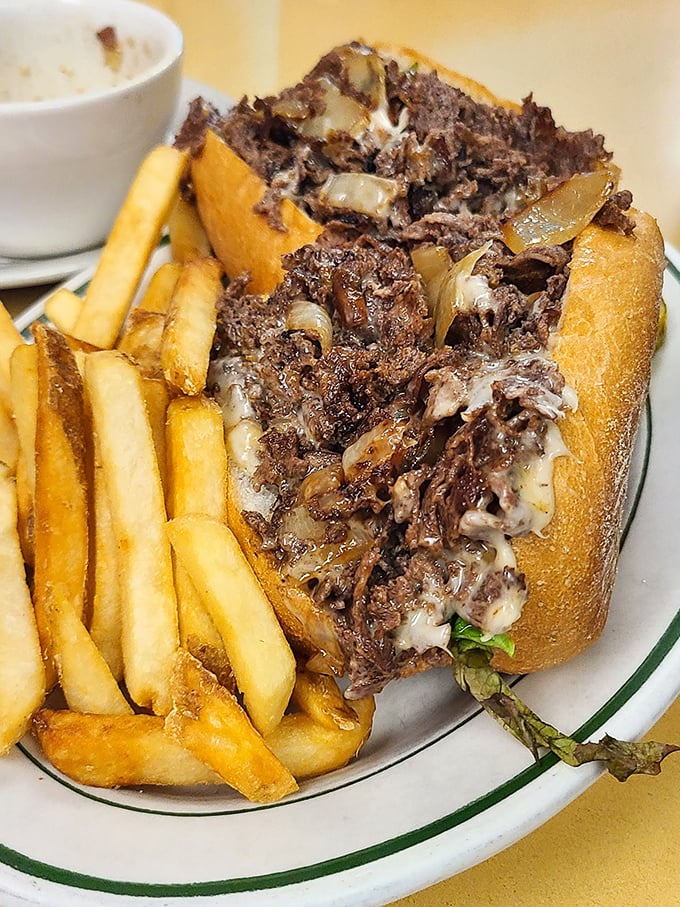 Not all heroes wear capes—some come on fresh rolls. This cheesesteak hoagie is the kind of sandwich that demands both hands and your full attention.