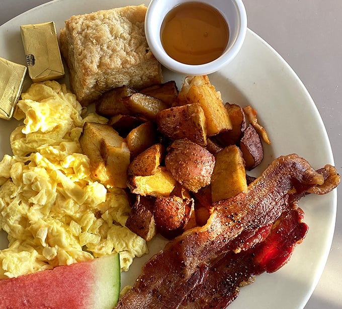 Breakfast of champions, Texas-style—golden scrambled eggs, crispy home fries, and bacon cooked to that perfect point between chewy and crisp.