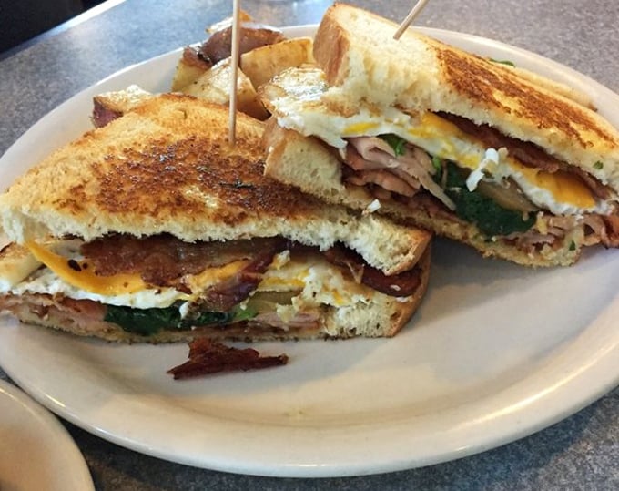 Breakfast architecture at its finest—layers of flavor stacked between perfectly toasted bread. The kind of sandwich that makes you forget all about your "healthy eating" resolutions.