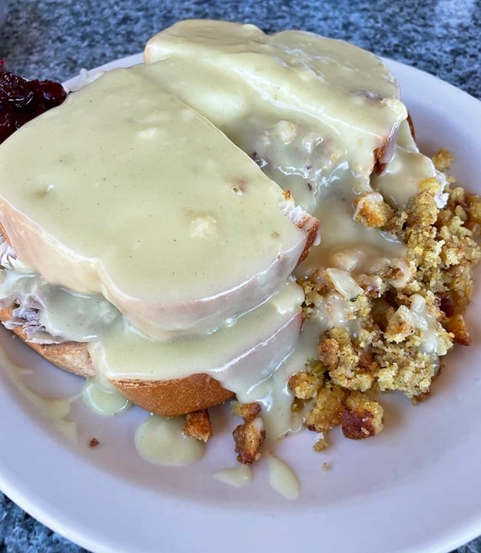 Behold the hot turkey sandwich—where gravy isn't just a topping but a warm, savory blanket tucking in layers of house-roasted turkey and stuffing.