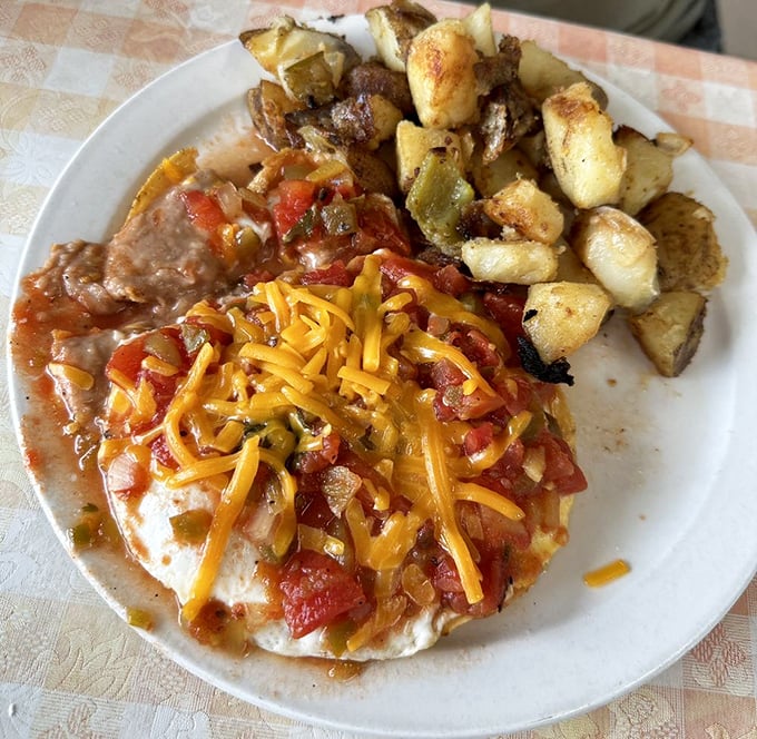 Huevos Rancheros that would make your abuela proud – a fiesta of flavors topped with melted cheese and served with potatoes that could convert any hash brown skeptic.