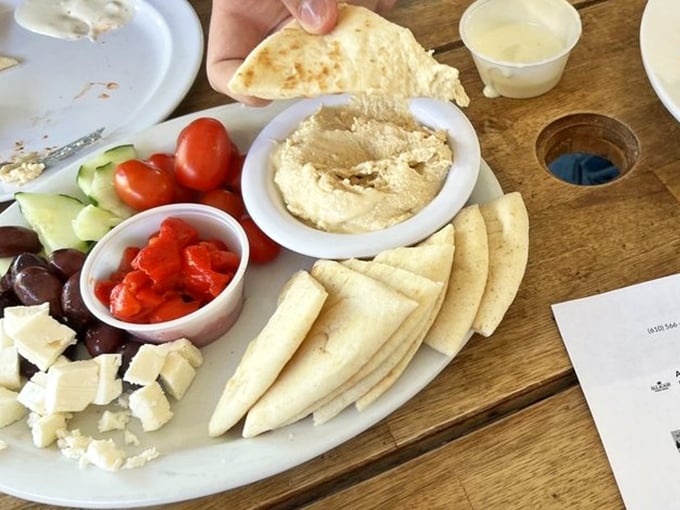 The Mediterranean platter arrives like a colorful United Nations of flavor—hummus, feta, and veggies playing together in perfect harmony. 