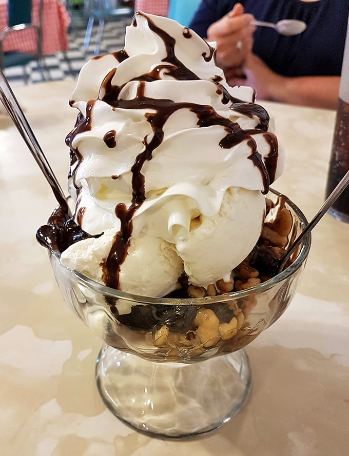 Ice cream sundaes should always require strategic planning. This mountain of vanilla, chocolate sauce, and whipped cream demands both commitment and napkins. 