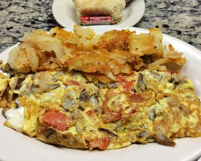 This isn't just an omelet—it's a masterpiece of morning architecture, with perfectly folded eggs cradling a treasure trove of fillings.