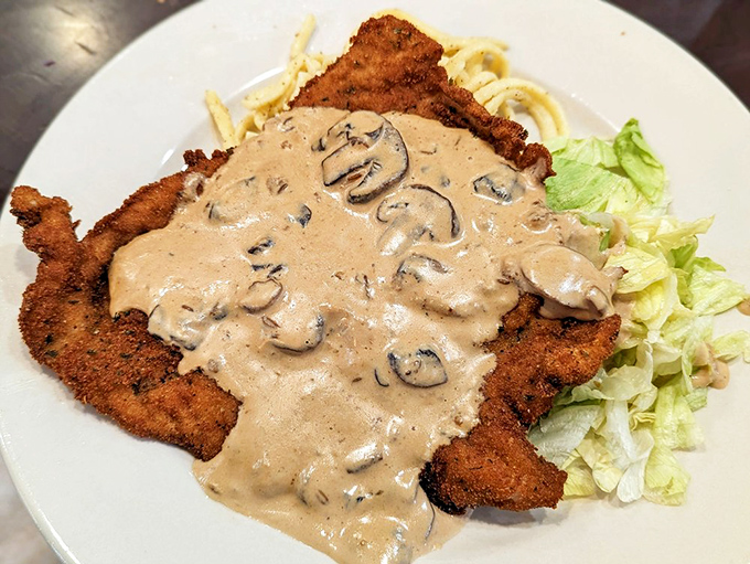 This Jaeger Schnitzel doesn't just come with mushroom sauce, it arrives swimming in a creamy forest of fungal perfection atop tender spätzle.