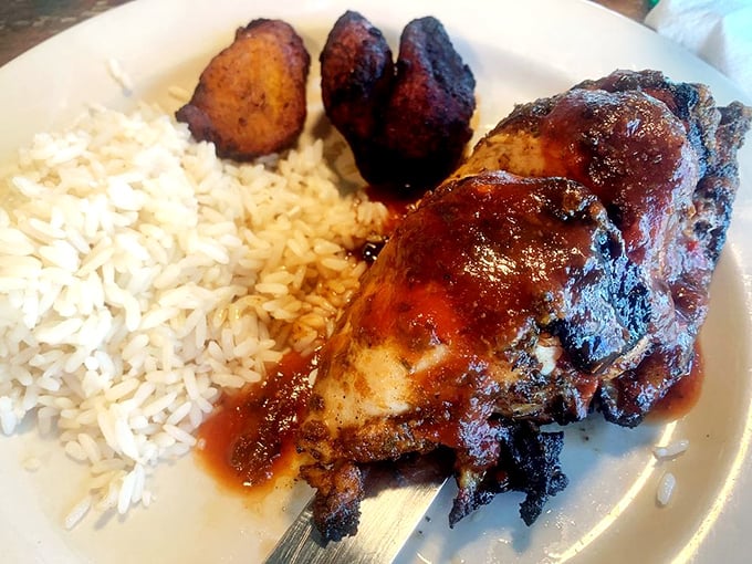 Jamaican Jerk Chicken with a side of plantains and rice—proof that Caribbean flavors and Florida sunshine are a match made in culinary heaven.