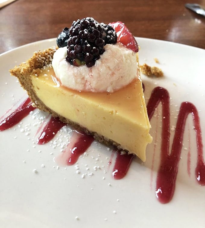 Key lime pie that strikes the perfect balance between sweet and tart. That dollop of whipped cream and fresh berries isn't just garnish—it's the exclamation point.