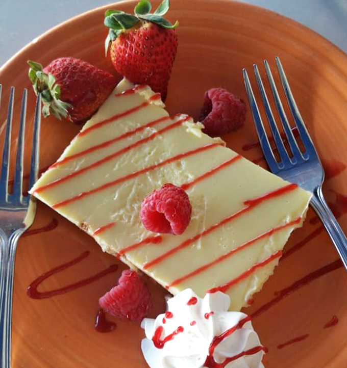 Key lime pie that strikes the perfect balance between tart and sweet—like Florida sunshine in dessert form, complete with berry companions.