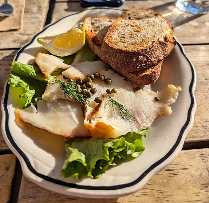 Smoked fish with capers and fresh bread—proof that breakfast can be sophisticated without being pretentious.