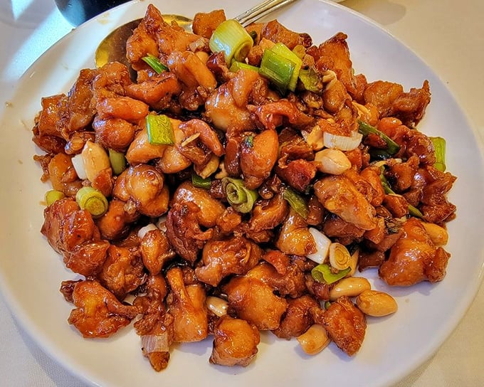 Kung Pao Chicken that puts mall food court versions to shame—crispy, glossy, and studded with green onions and peanuts for that perfect crunch.