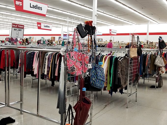 The ladies' clothing department – a fabric rainbow where vintage treasures and barely-worn bargains hang side by side in perfect harmony.