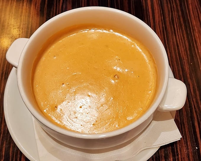This lobster bisque isn't just soup—it's liquid velvet with a college degree. The golden hue promises (and delivers) richness that makes you want to propose to your spoon.