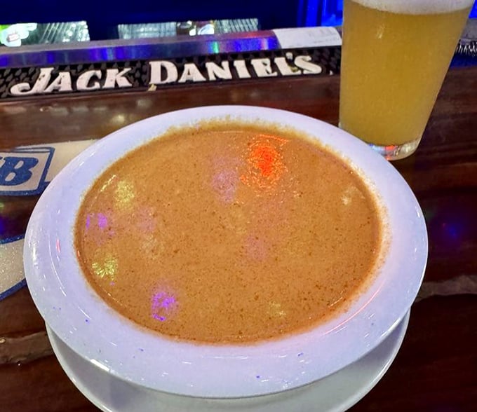 The lobster bisque glows with a sunset-orange hue, promising a velvety ocean of flavor with each spoonful.