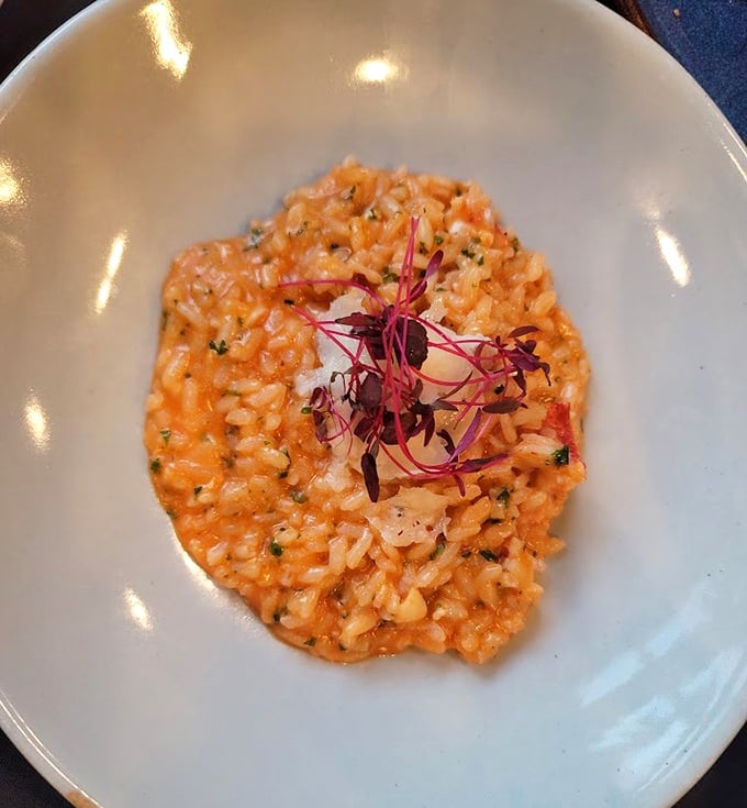 This lobster risotto isn't just a dish—it's a sunset-colored canvas of creamy perfection topped with delicate microgreens. Comfort food dressed for the opera.