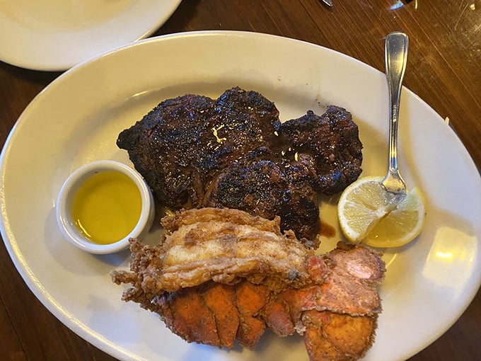 A surf and turf affair that doesn't need to shout – perfectly seared steak alongside golden-fried lobster tail, proving simplicity is the ultimate sophistication.