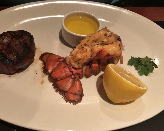 The surf-and-turf pairing that dreams are made of – a buttery lobster tail that practically begs to be dipped in that golden sauce.