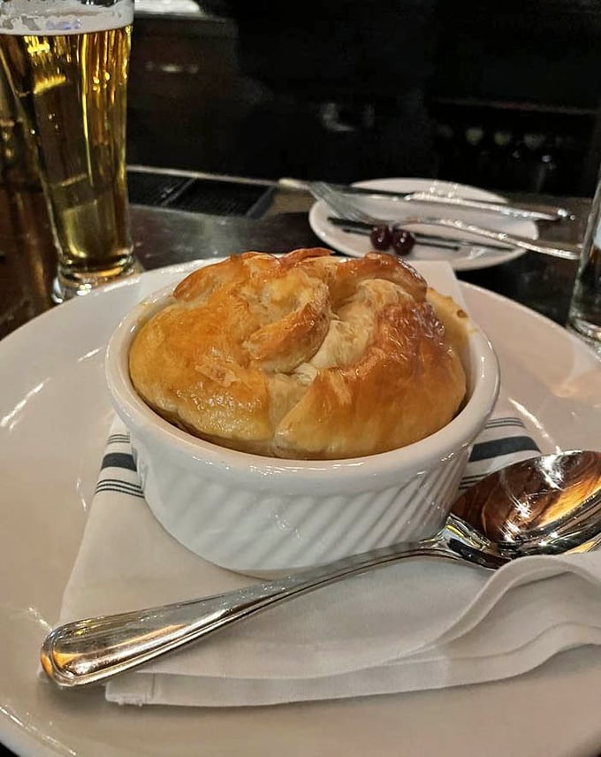 Not your average pot pie—this golden-domed creation houses a steamy treasure of lobster beneath its flaky, buttery crust.
