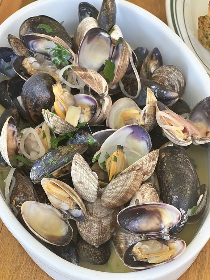 These steamed mussels and clams aren't just seafood—they're a briny symphony in a bowl, each shell opening to reveal a perfect morsel of ocean treasure.