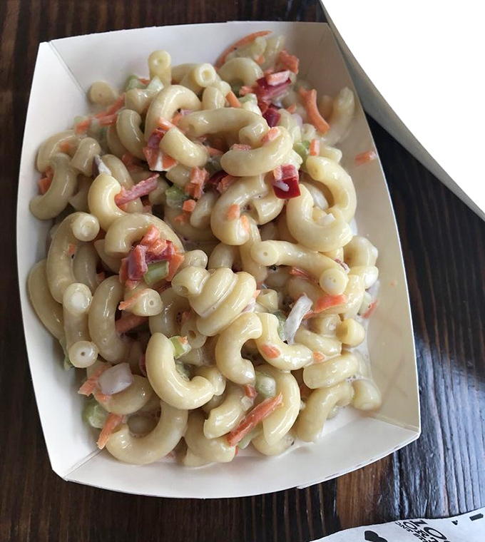 This isn't just macaroni salad; it's a pasta party where every elbow brought friends. The vegetables add color, crunch, and the illusion of healthfulness.