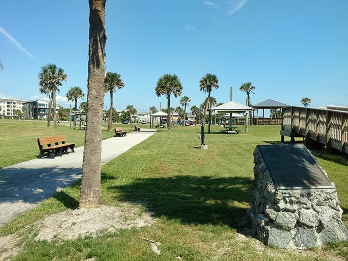 Palm trees standing guard over picnic pavilions at Main Beach Park—nature's perfect combination of shade and sunshine for your afternoon escape.