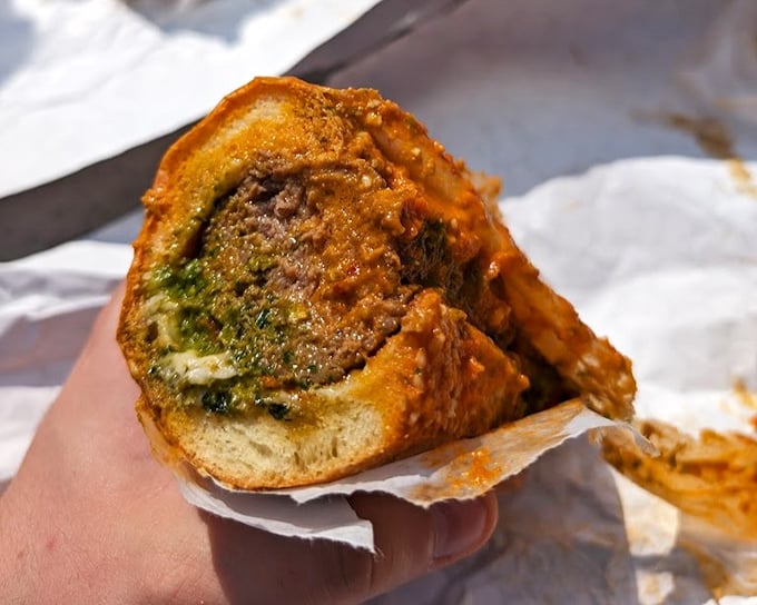 Behold the meatball sub in its natural habitat—a study in contrasts with golden-brown exterior and savory filling that demands your full attention.