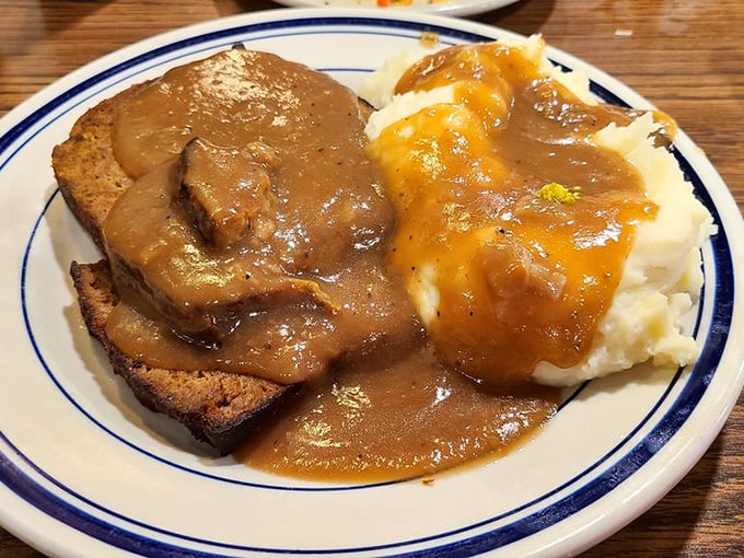 Meatloaf and mashed potatoes swimming in gravy—the kind of plate that makes you want to call your cardiologist and apologize in advance.