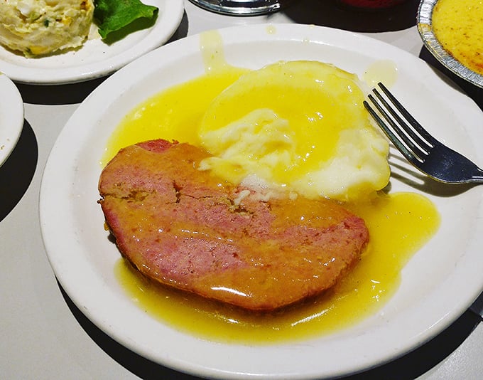 The meatloaf and mashed potatoes swim in a lake of golden gravy—a combination so classic it should have its own spot on the periodic table of comfort foods.
