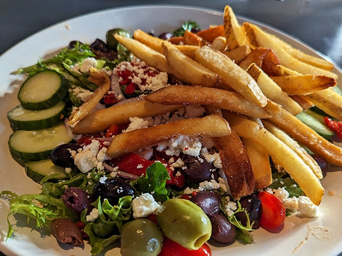 A Mediterranean salad that actually makes you excited about eating vegetables—crisp, colorful, and proof that fries and salad can peacefully coexist on one plate.