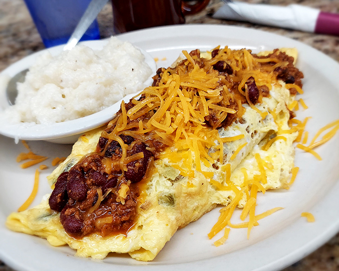 This omelet doesn't just have fillings—it has ambitions. Topped with chili and cheese, it's the breakfast equivalent of wearing a sombrero to a board meeting.